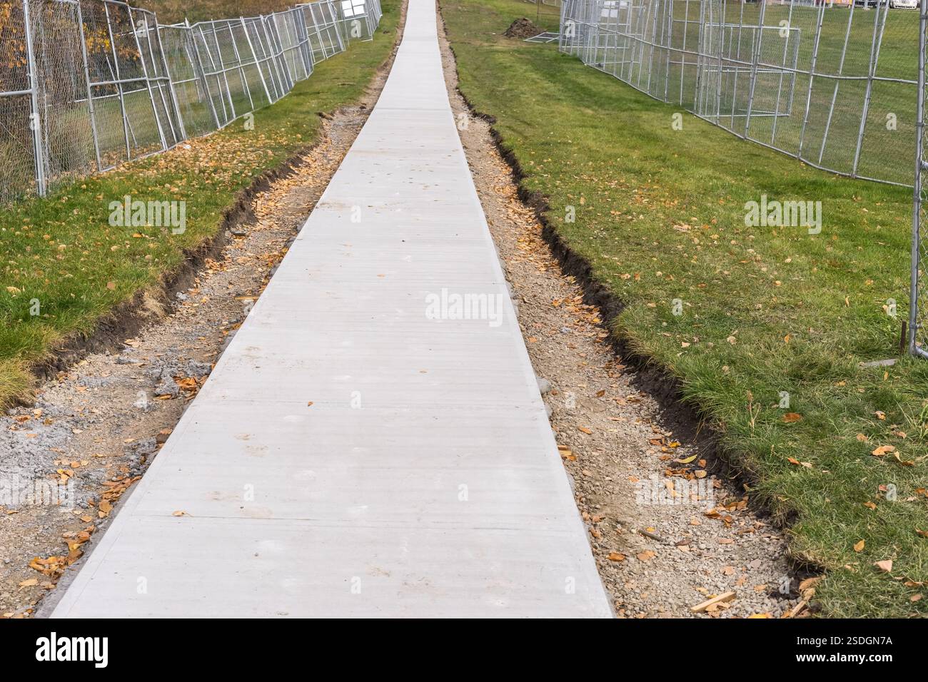 Footpath construction concrete curing guarded with metal fence Stock ...