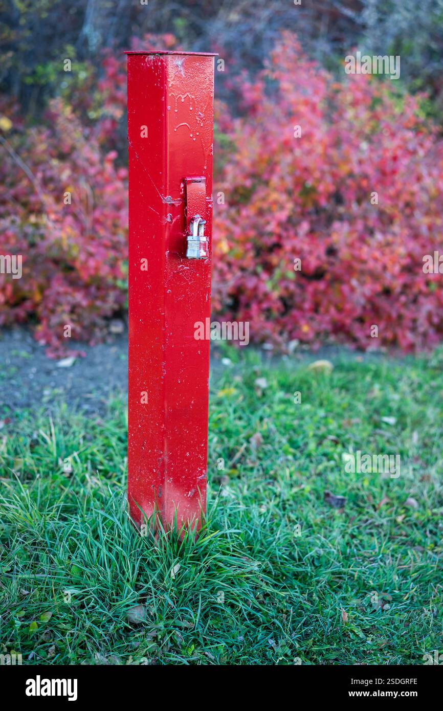 Power outlet protected with metal box, locked and painted in red on ...