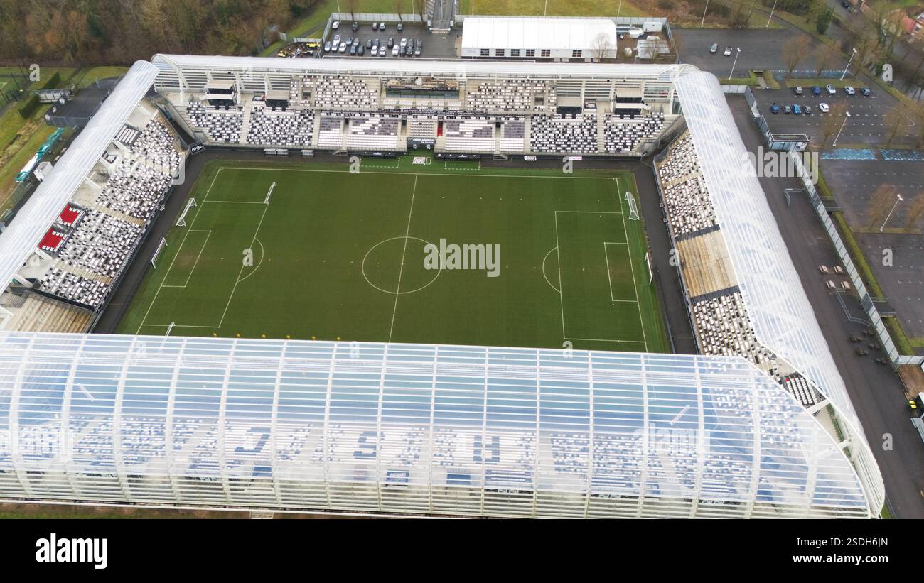 Aerial view of a modern football stadium featuring empty stands, a well ...