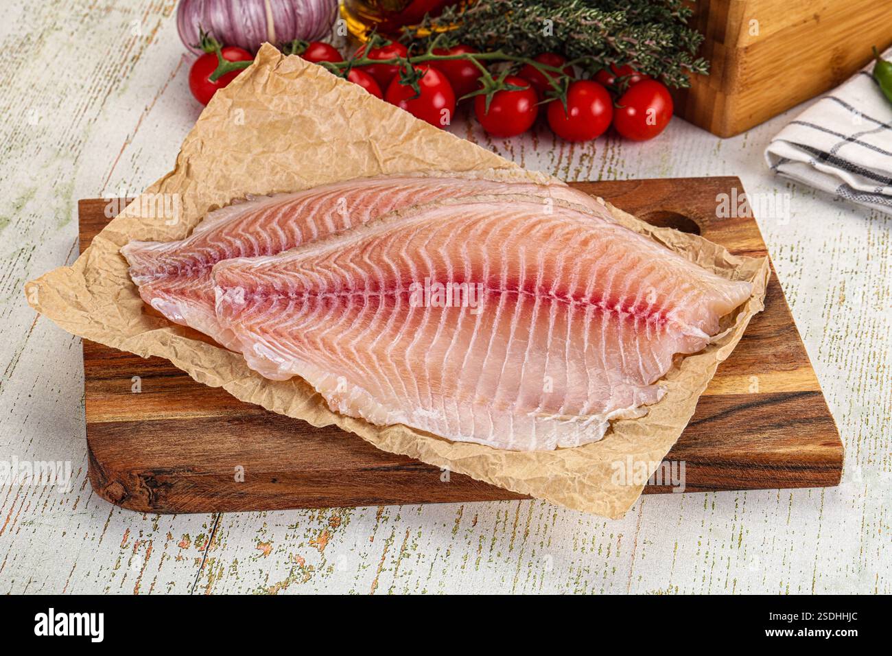 Raw Tilapia fish fillet slice uncooked Stock Photo - Alamy
