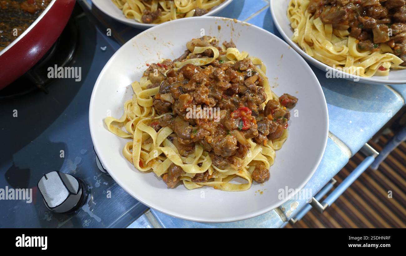 Tagliatelle with wild boar ragu, freshly plated Stock Photo - Alamy