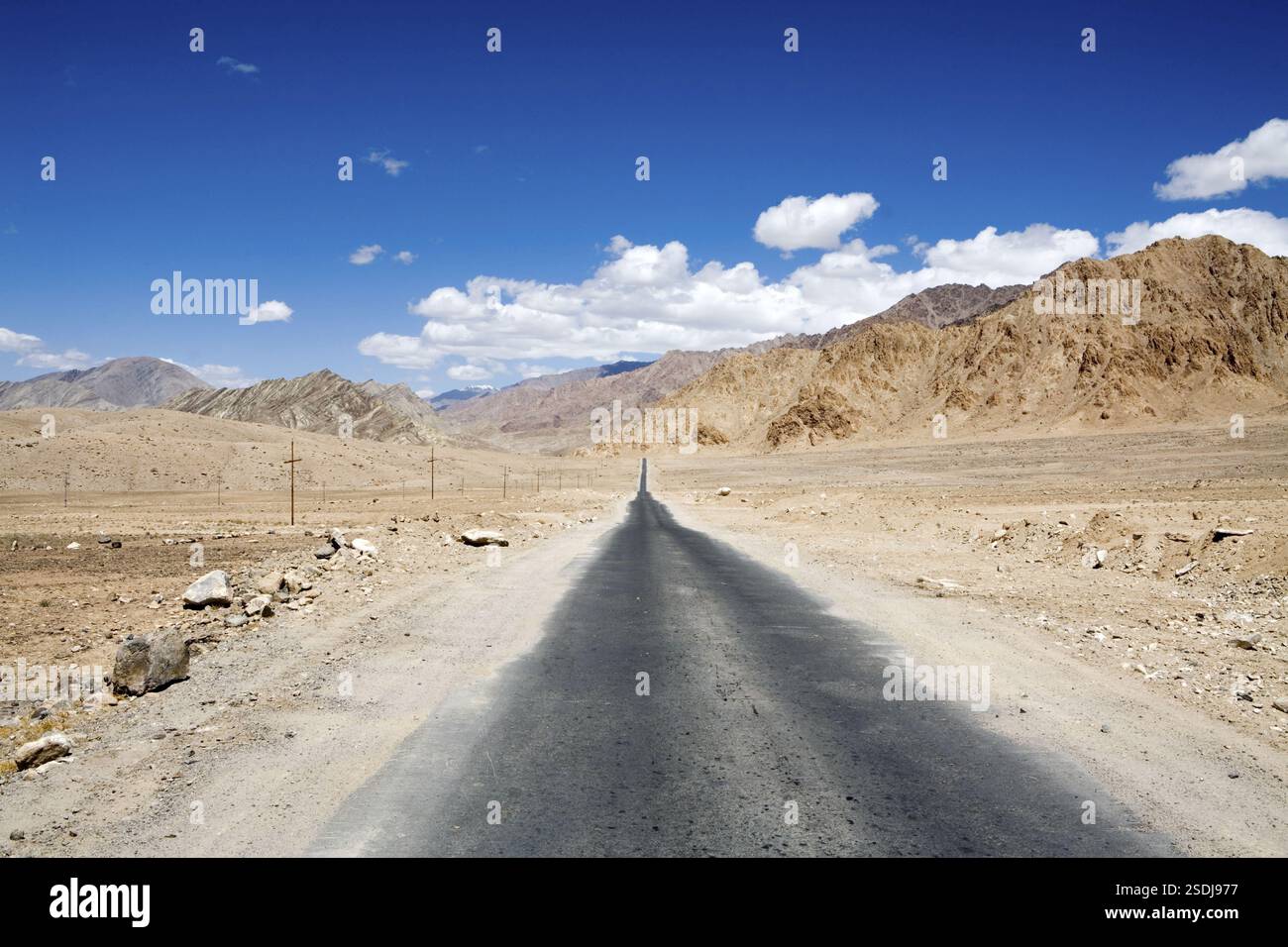Narrow tar bitumen road on Leh Kargil stretch in landscape of Ladakh ...