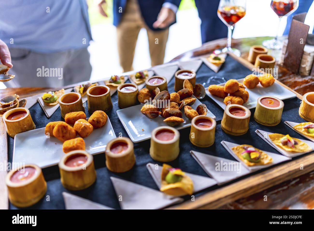 Gourmet appetizers beautifully arranged on a tray at a wedding reception, featuring various ...