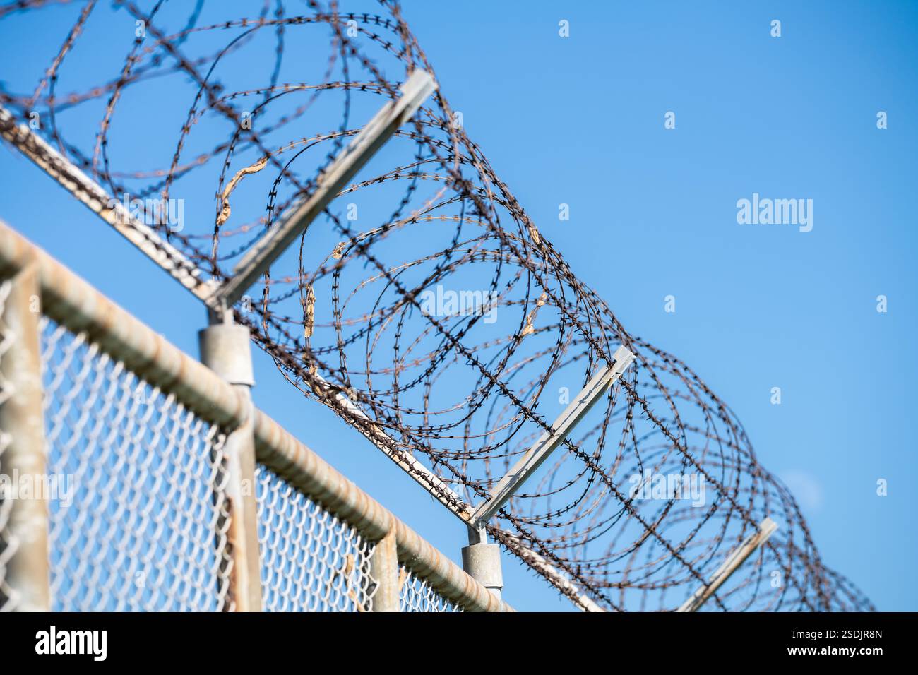 Barbed wire fence symbolizing border control, geopolitical tensions ...