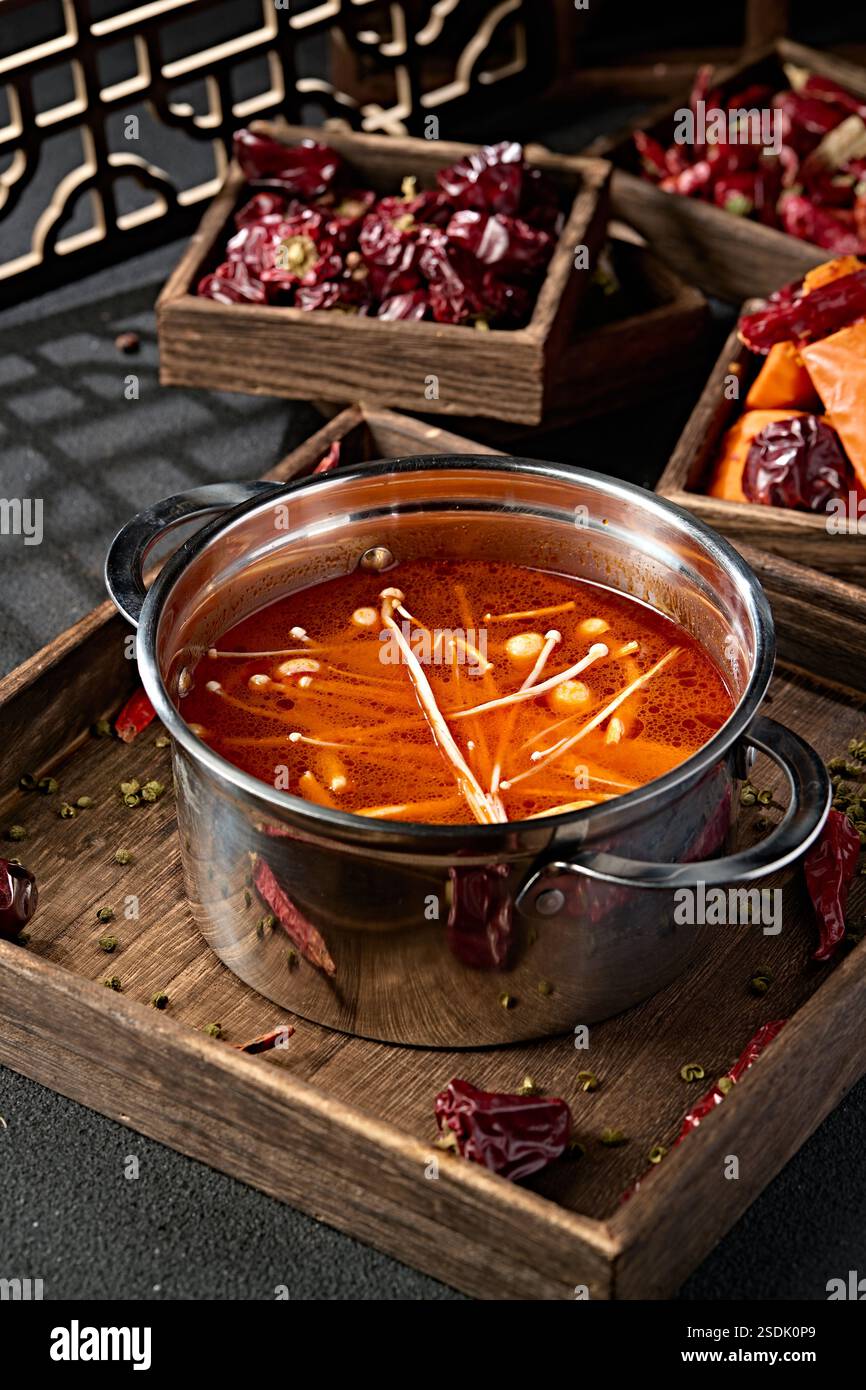 Mini hot pot soup base tomato mushroom soup base Stock Photo - Alamy