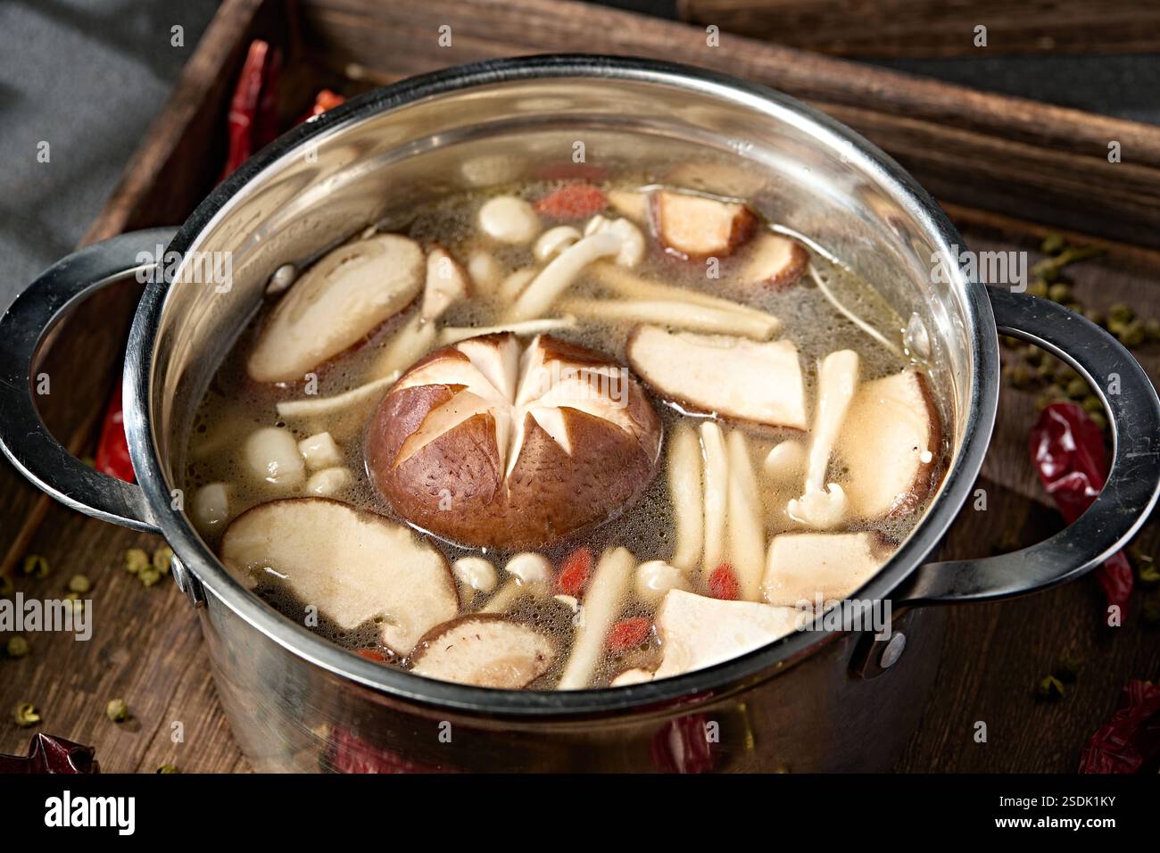 Mini hot pot mushroom soup base Stock Photo - Alamy