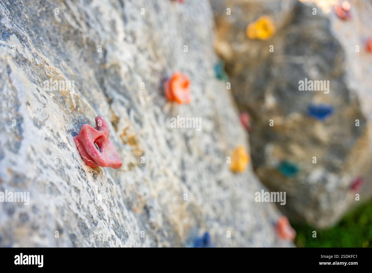 Close up view of a short rock climbing wall on the playground, concept ...