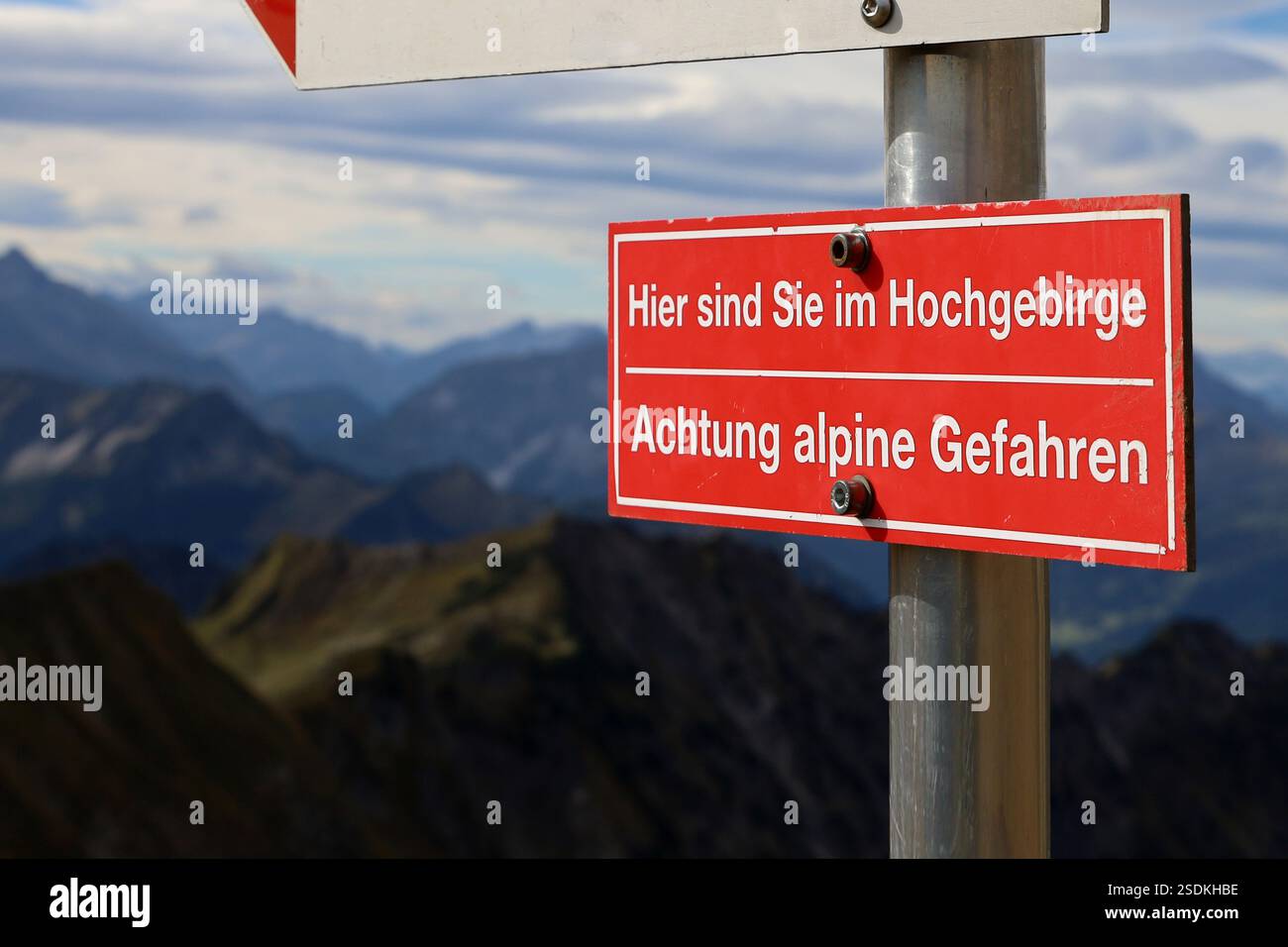 Red warning sign in the Alps with German inscription: Here you are in ...