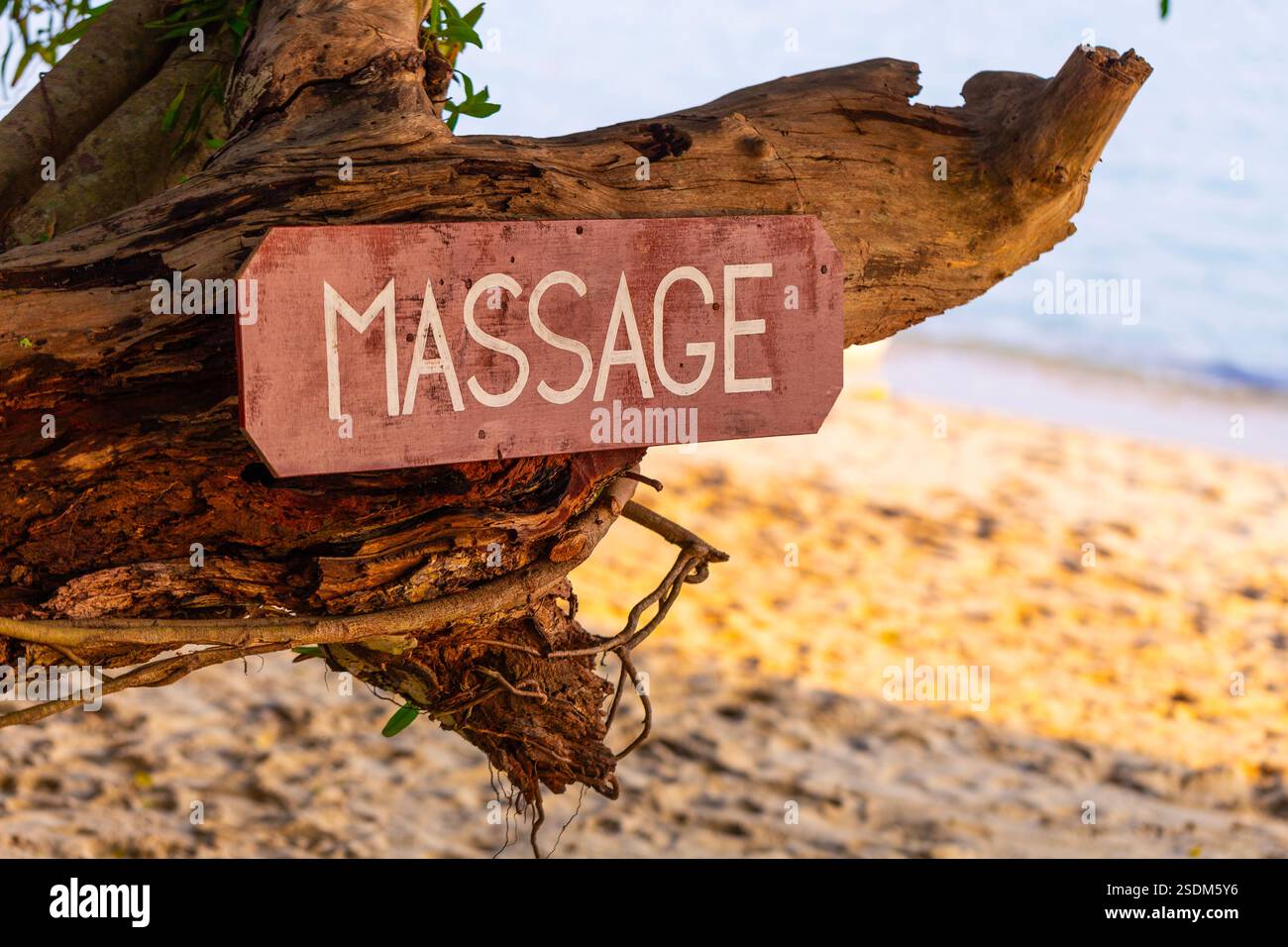 Old signboard with the inscription, massage, on a tropical beach ...