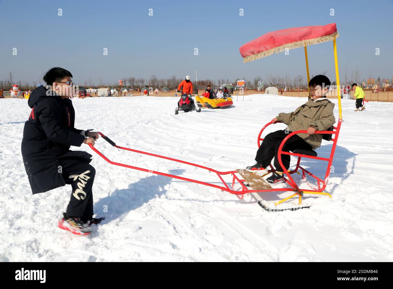Tourists enjoy snow fun at a snow park in Lianyungang City, east China ...