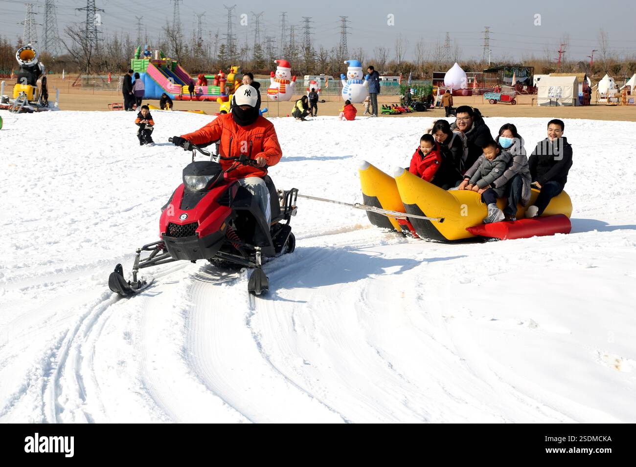 Tourists enjoy snow fun at a snow park in Lianyungang City, east China ...