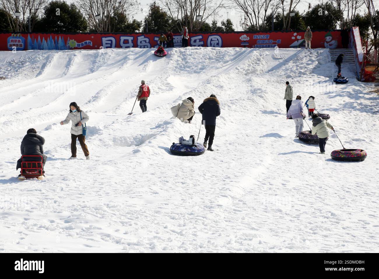 Tourists enjoy snow fun at a snow park in Lianyungang City, east China ...