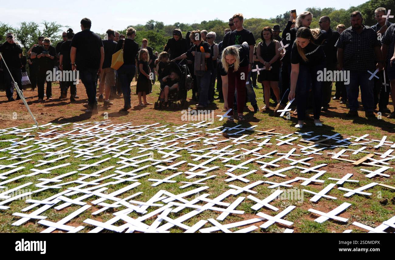 FILE - People place white crosses representing farmers killed in the ...