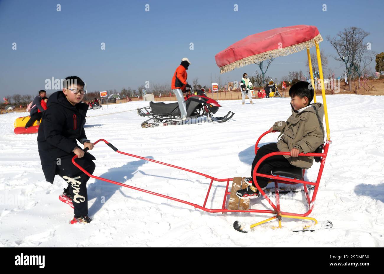 Tourists enjoy snow fun at a snow park in Lianyungang City, east China ...
