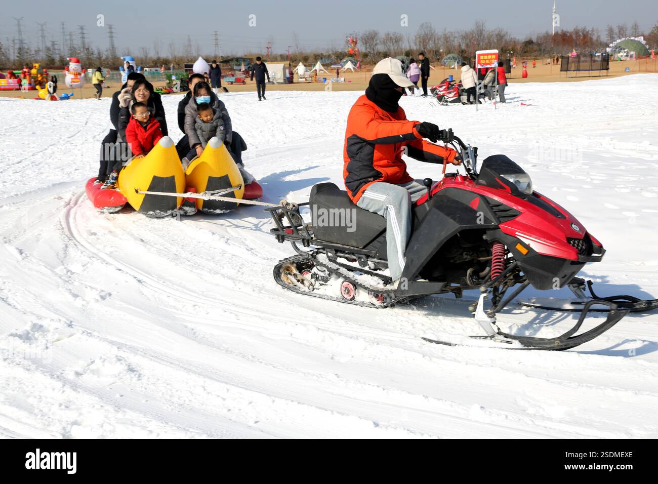 Tourists enjoy snow fun at a snow park in Lianyungang City, east China ...