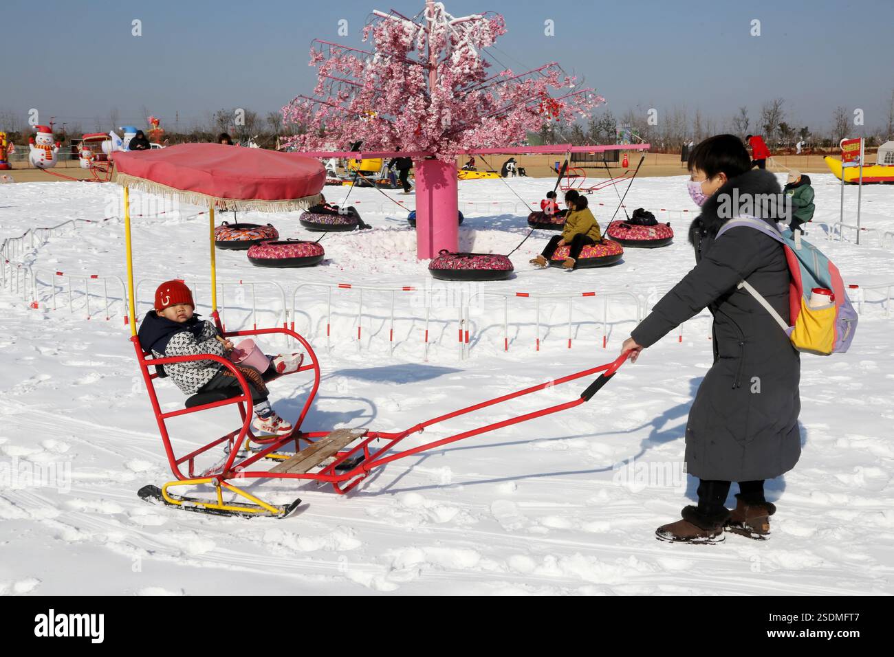 Tourists enjoy snow fun at a snow park in Lianyungang City, east China ...