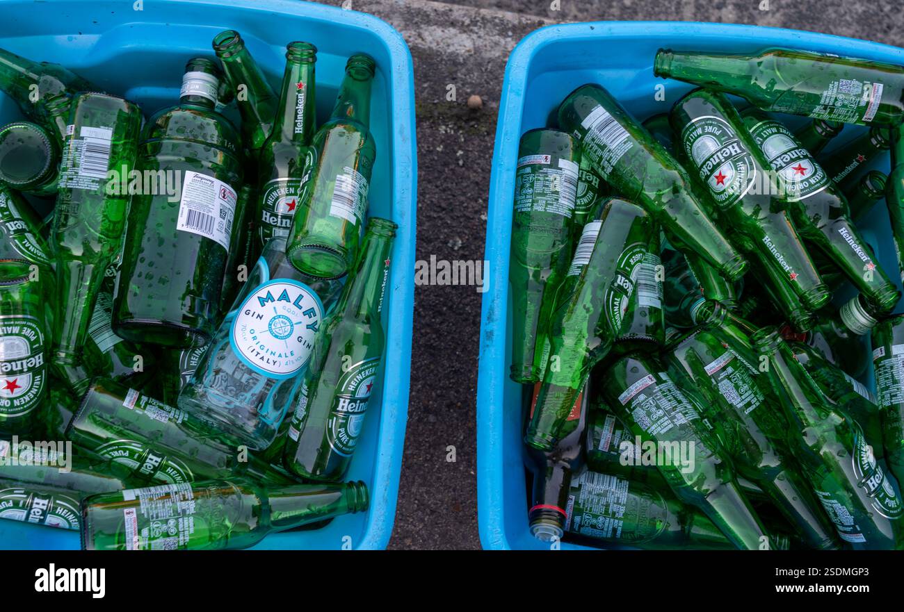 Tauranga New Zealand - February 3 2025; Glass recycling bins full of empty alcohol bottles ready ...