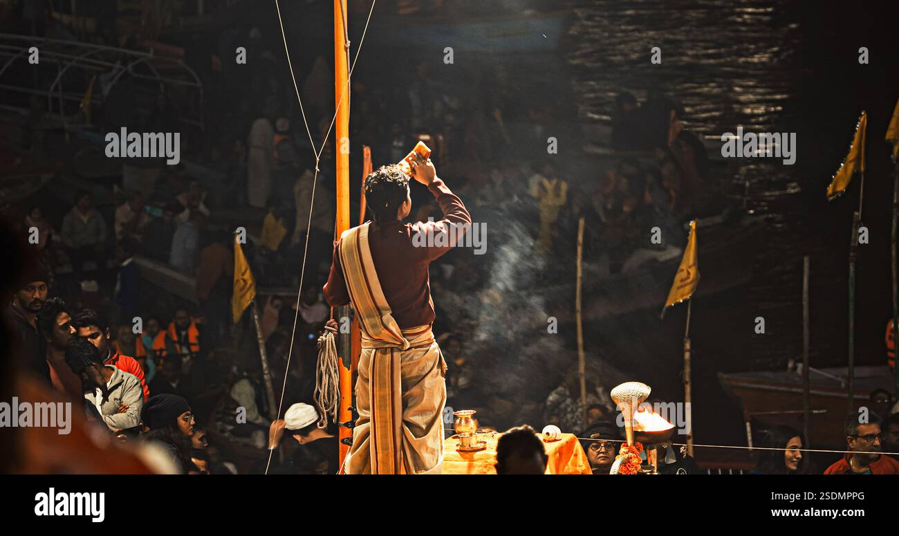 Varanasi, India. Brahmin Priest Making Movements With Flowers Marigolds ...