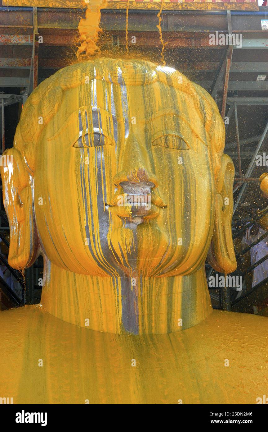 Turmeric water pouring on face of 57 feet high statue of lord Bahubali ...