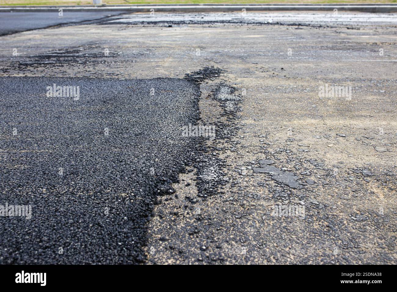 Close-up of an uneven asphalt surface, showing texture and contrast ...