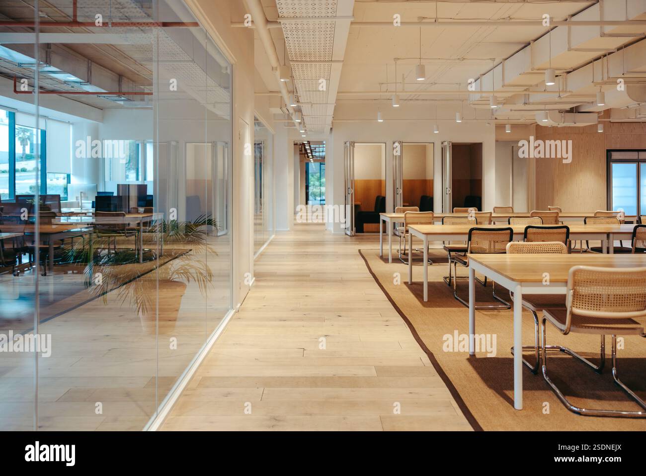 The image captures a modern coworking office with open seating and ...