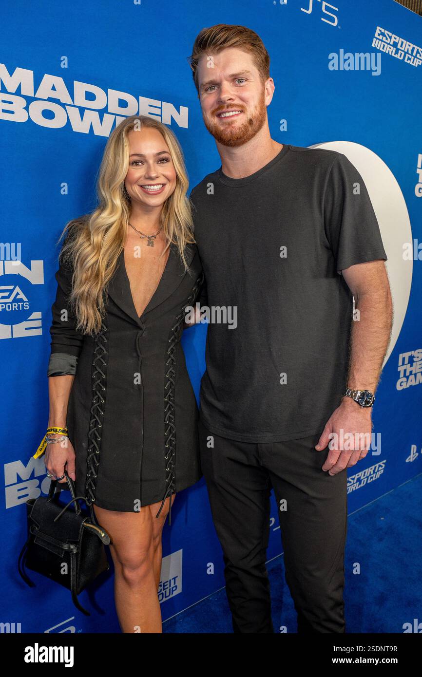 Katie Hoofnagle, left and Sam Darnold attend the EA Sports Madden Bowl ...