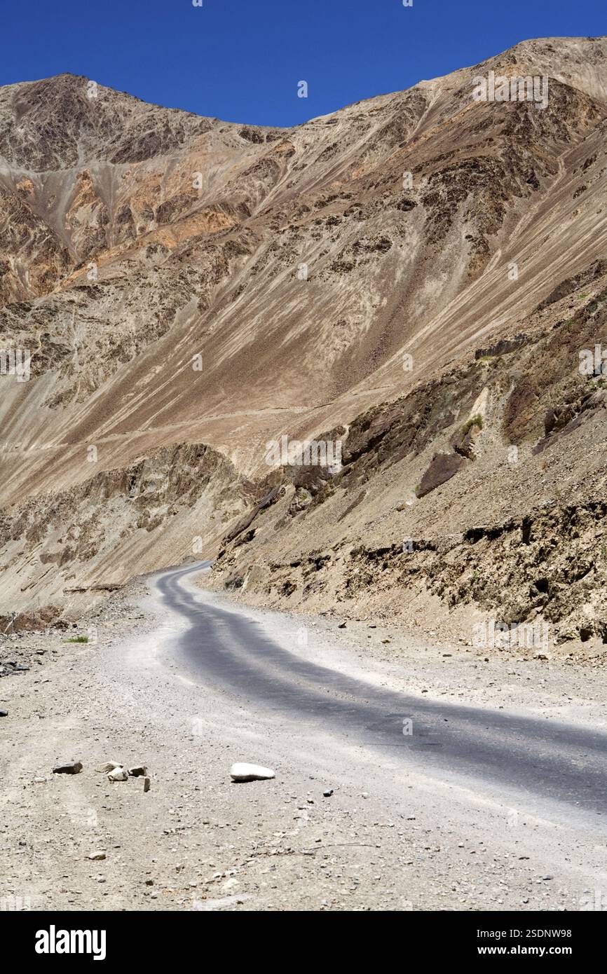 Narrow tar bitumen road on Leh Kargil road stretch in barren cold ...