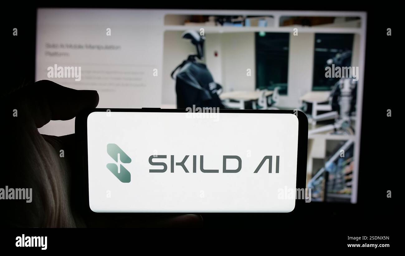 In this photo illustration, a person is holding a cellphone with the logo of US robotic ...