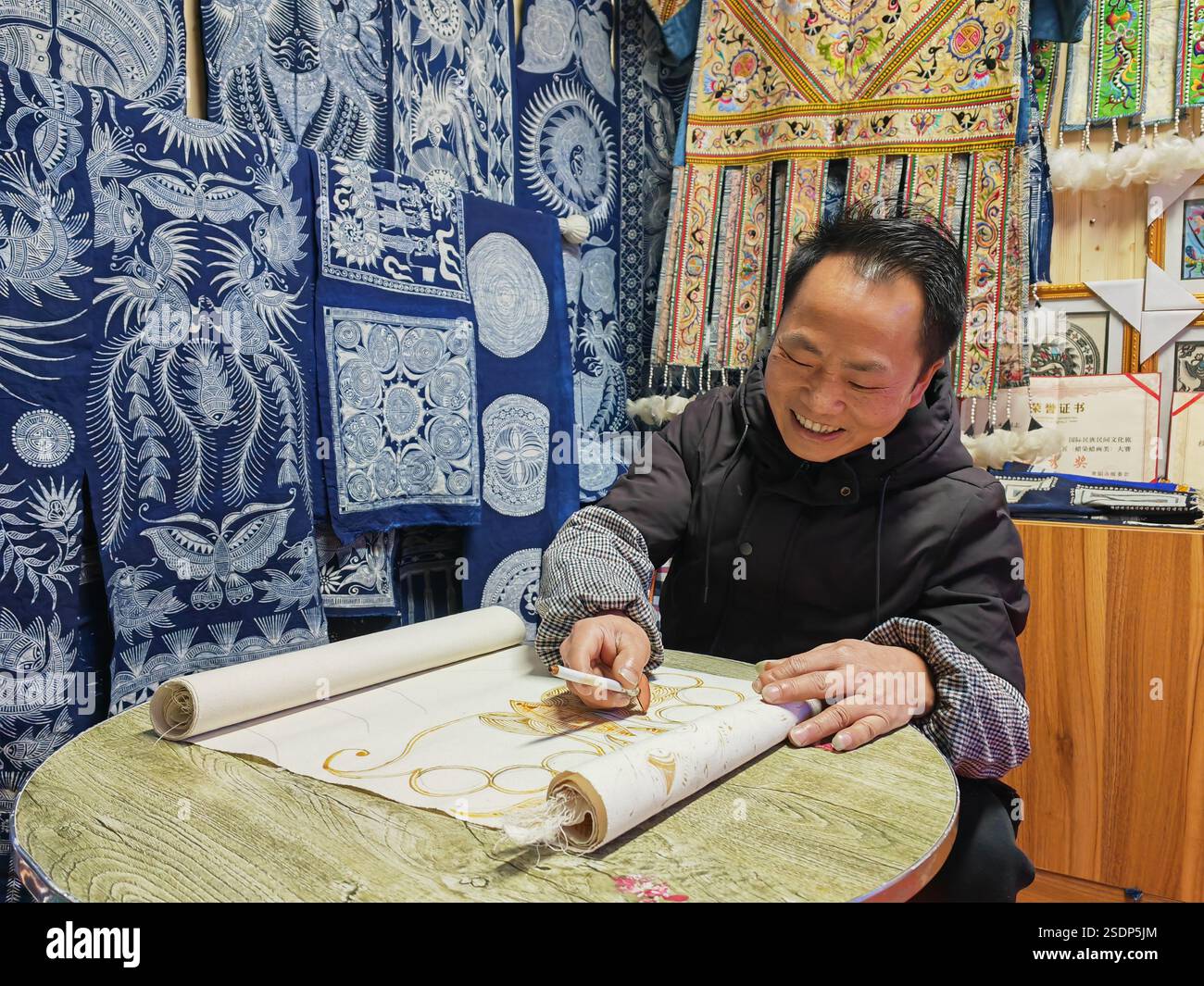 Guiyang. 9th Jan, 2025. Miao ethnic craftsman Wan Yuan makes batik at ...