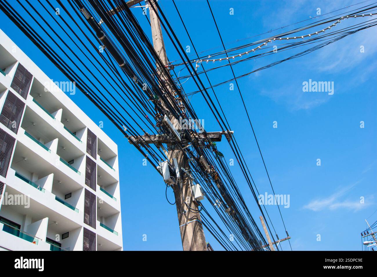 Intertwining of many electrical wires on poles Stock Photo - Alamy