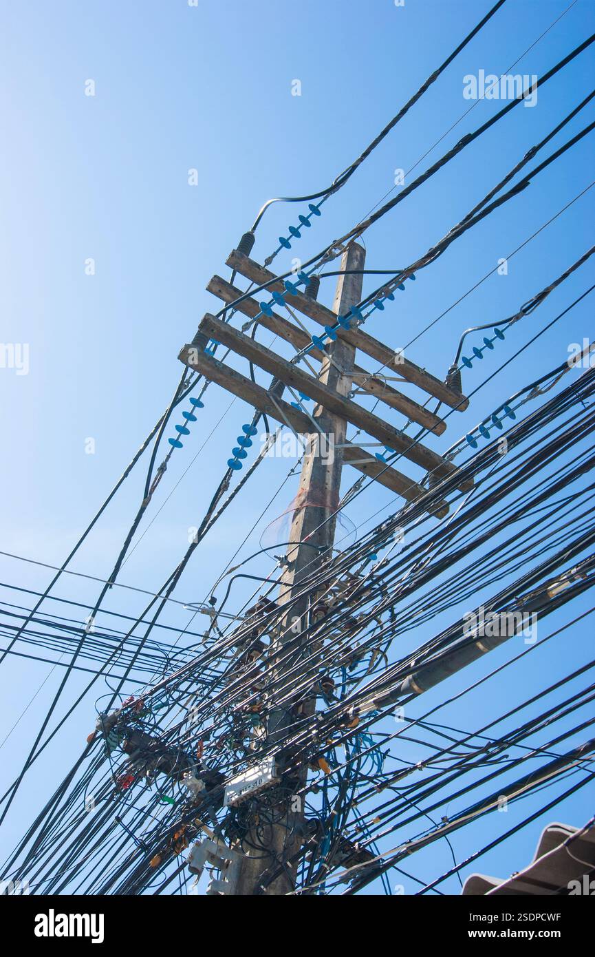 Intertwining of many electrical wires on poles Stock Photo - Alamy