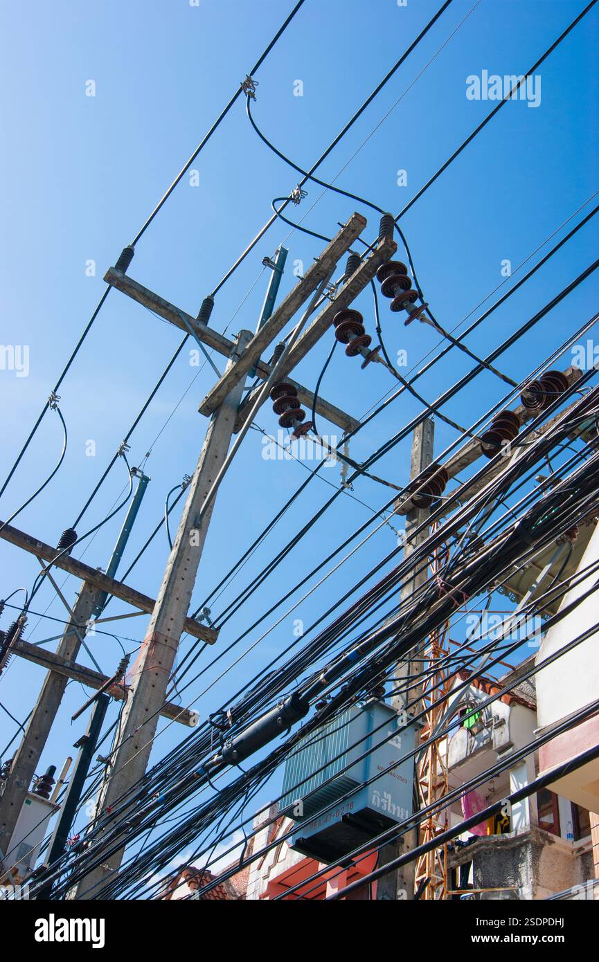 Intertwining of many electrical wires on poles Stock Photo - Alamy