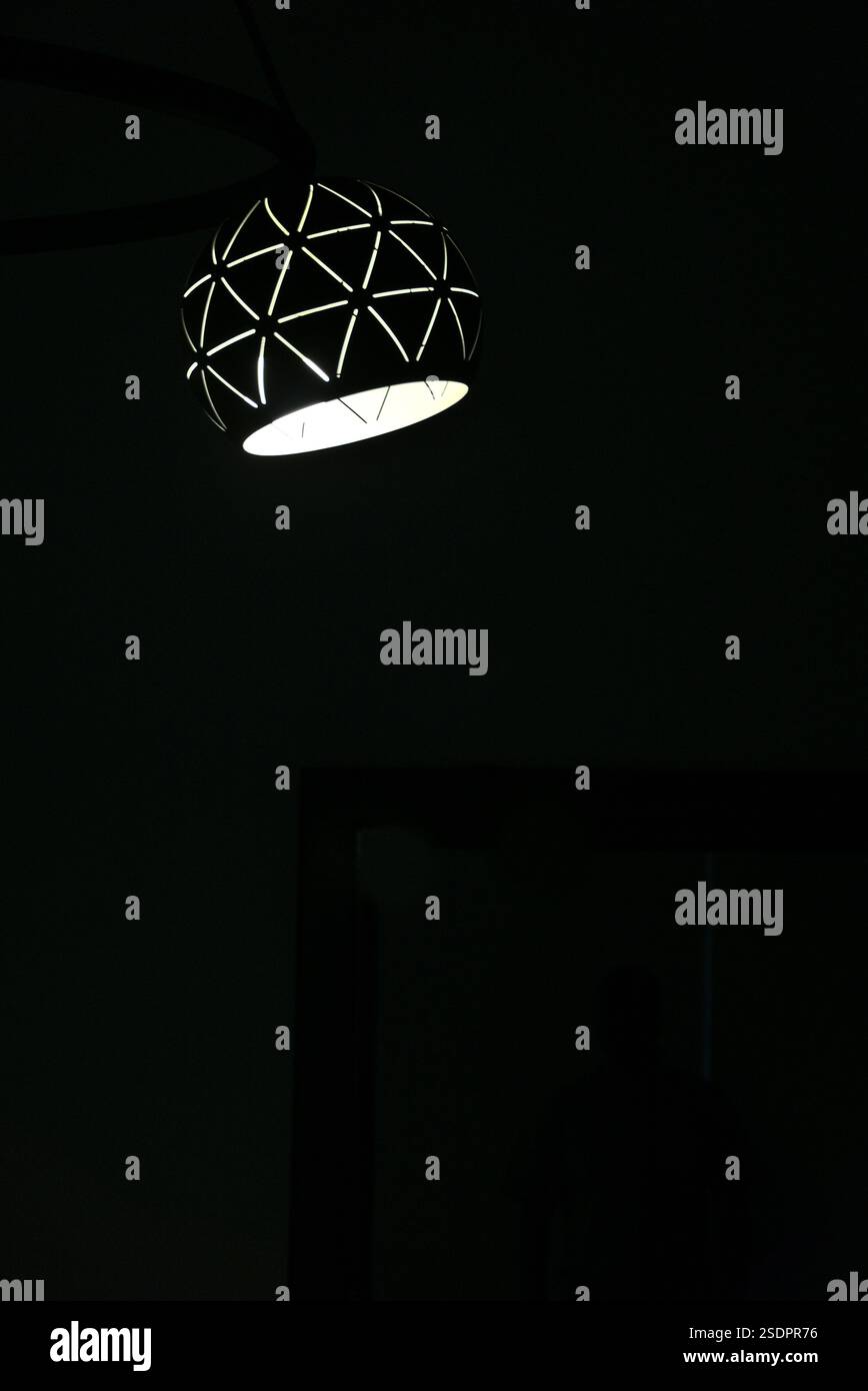 single bright light source against a black background minimalist ...