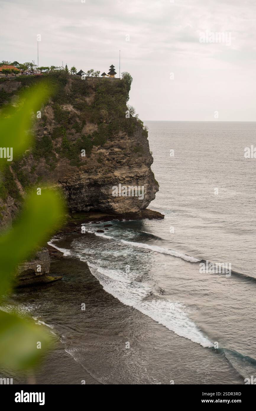 Uluwatu Temple perches dramatically atop a sheer limestone cliff, where ...