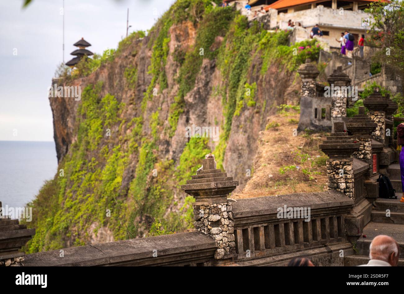 Ancient stone pathway with ornate pillars stretches along Uluwatu's ...