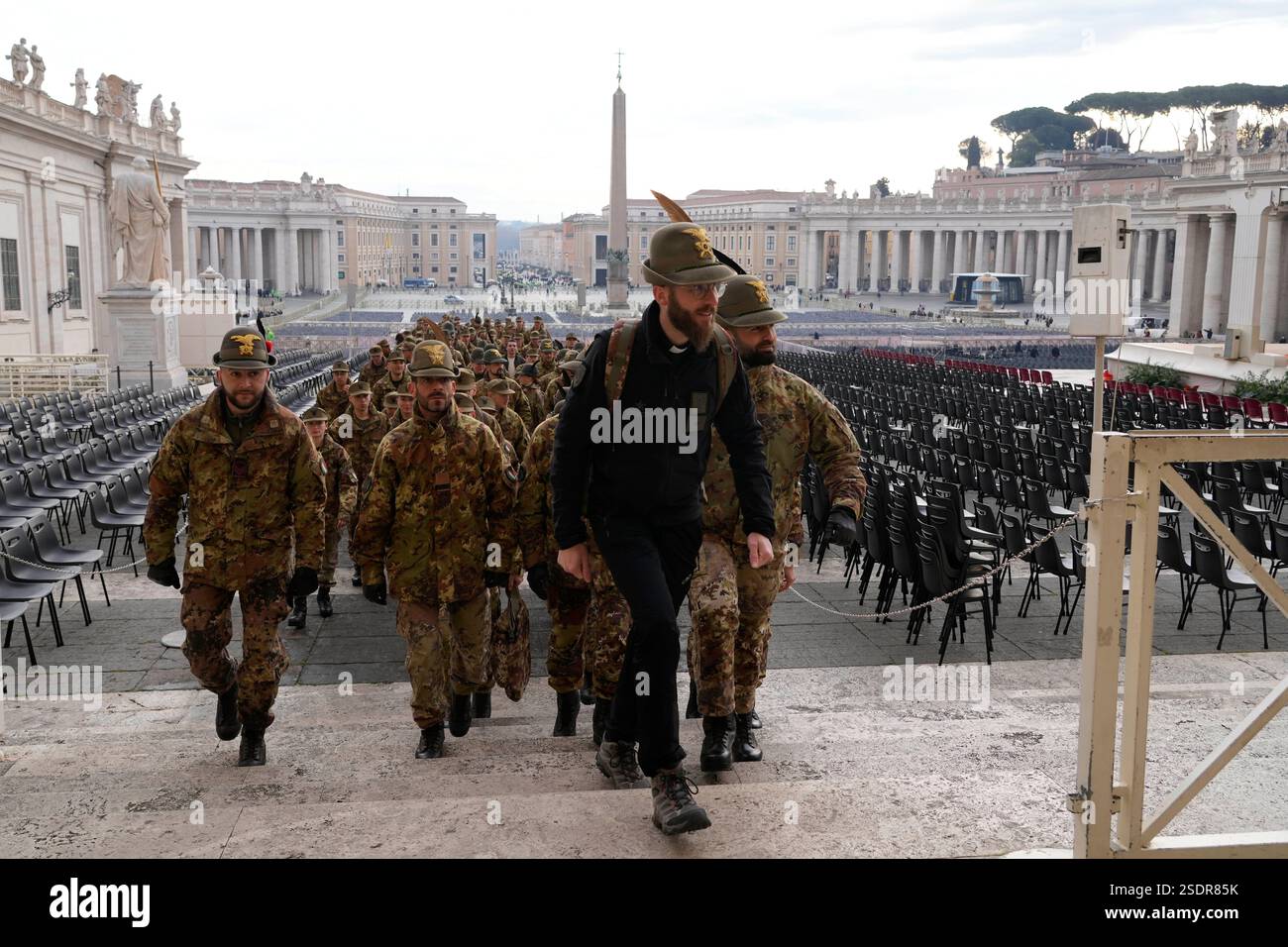 Members of the military walk towards St. Peter Basilica's holy door, on ...