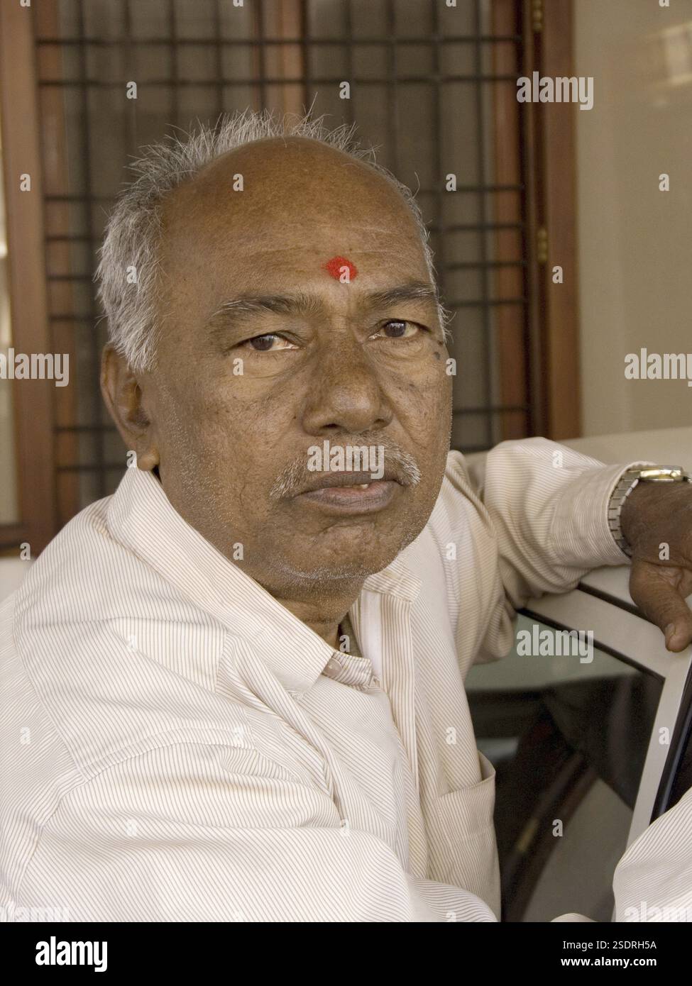 Old Indian man with red tilak on forehead looking at camera, Model ...