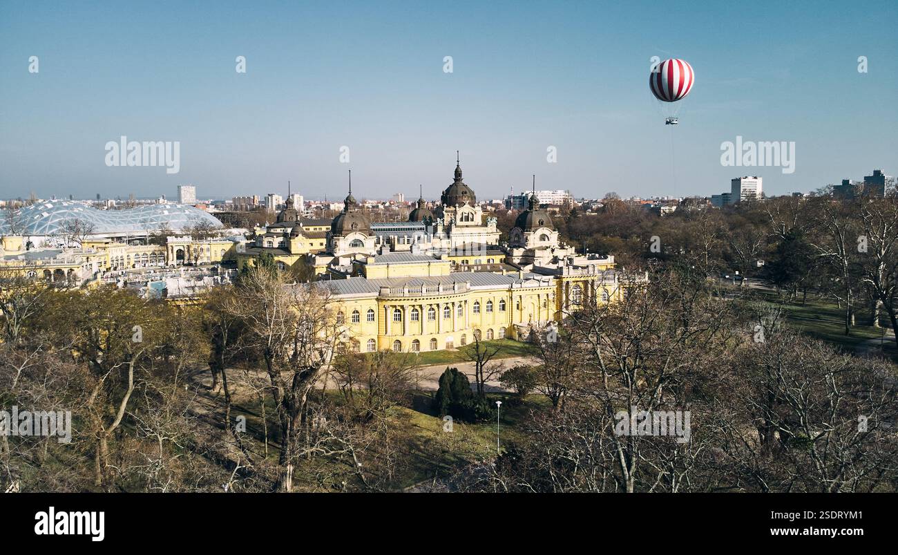 Aerial Capture of a Historic Building Surrounded by a Colorful Hot Air ...