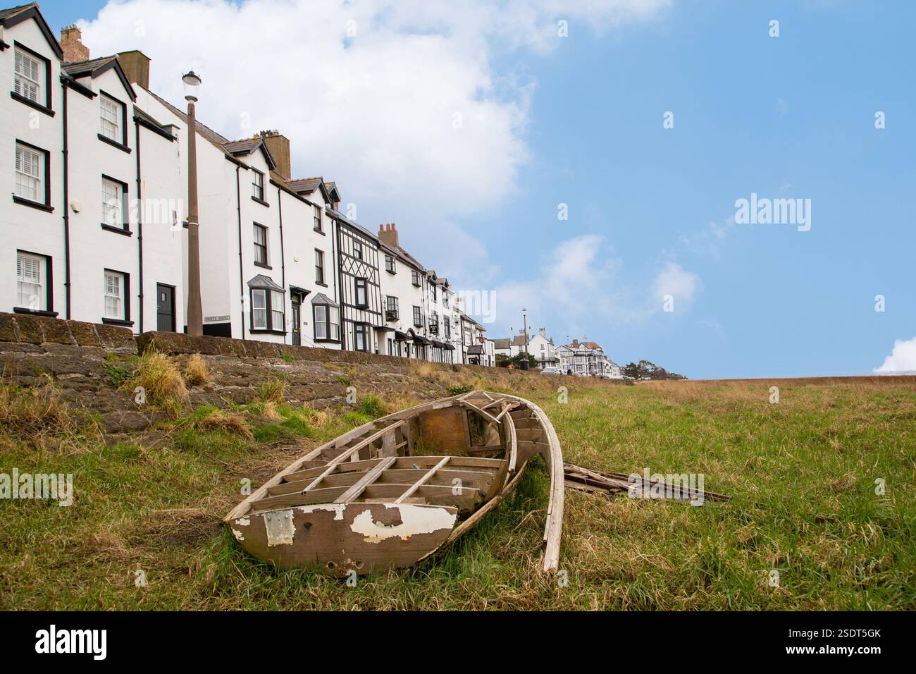 The remains of an abandoned fishing boat washed up on the salt marshes ...