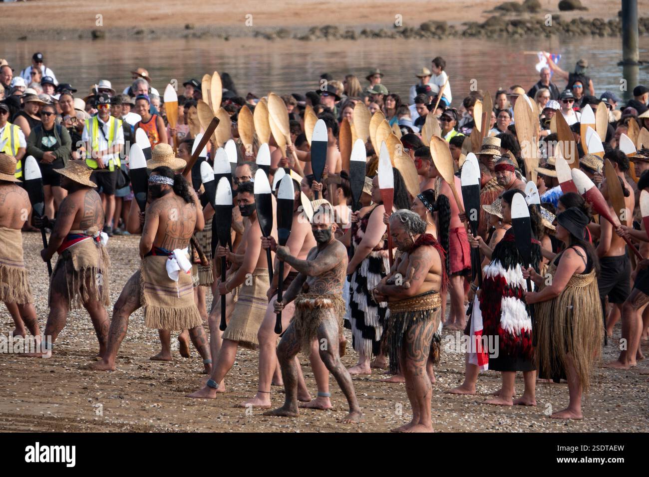Maori waka crew perform a haka on the beach during Waitangi Day ...