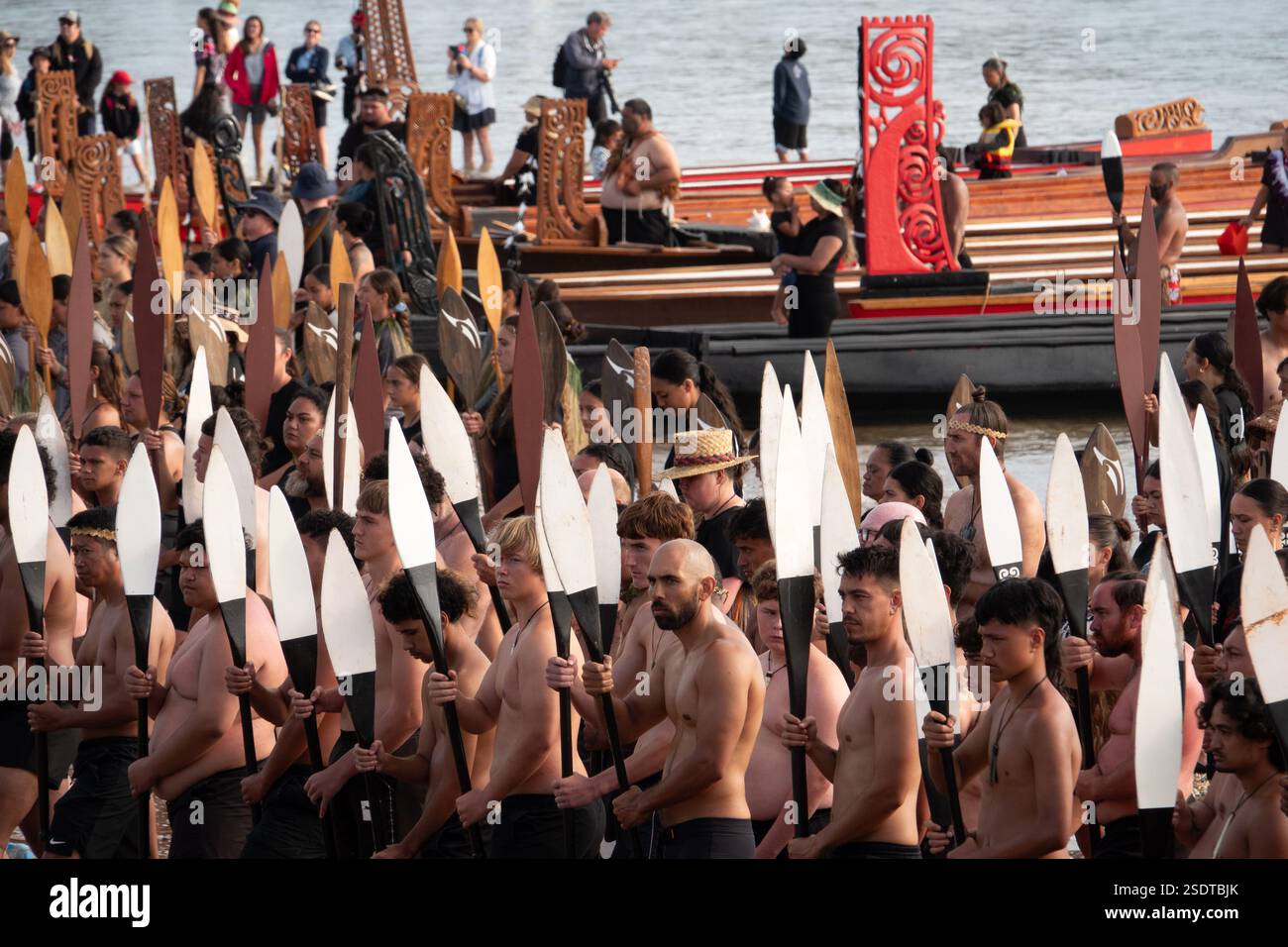 Maori waka crew perform a haka on the beach during Waitangi Day ...