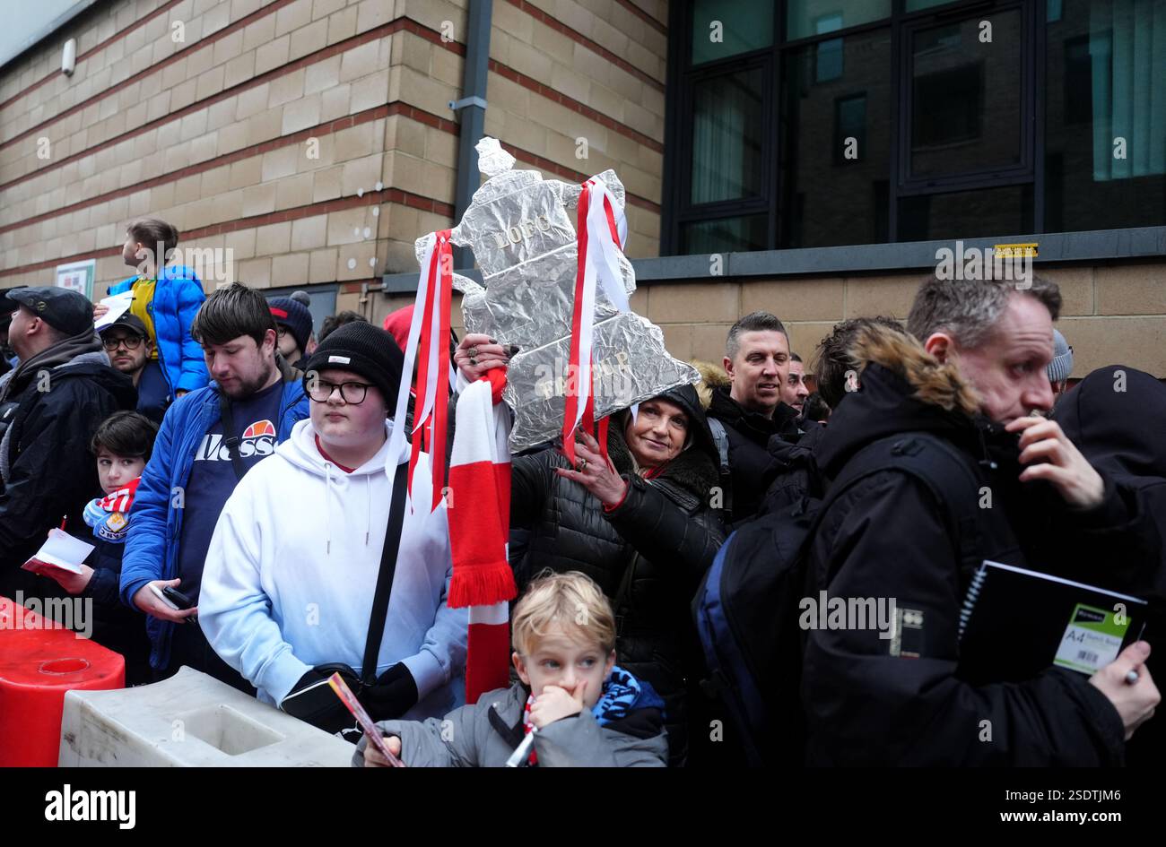A Leyton Orient fan holding a tin foil trophy outside the ground before ...