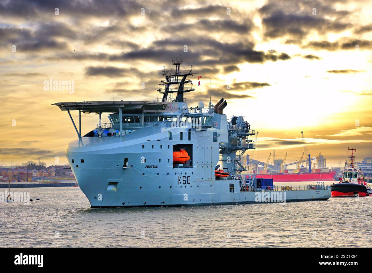 RFA Proteus K60 resupply RN ship leaving the river Tyne against sunset ...