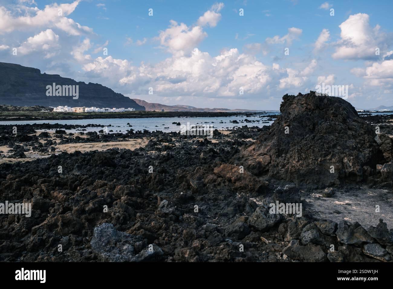 Breathtaking volcanic scenery with ebony sands, dramatic peaks, and ...