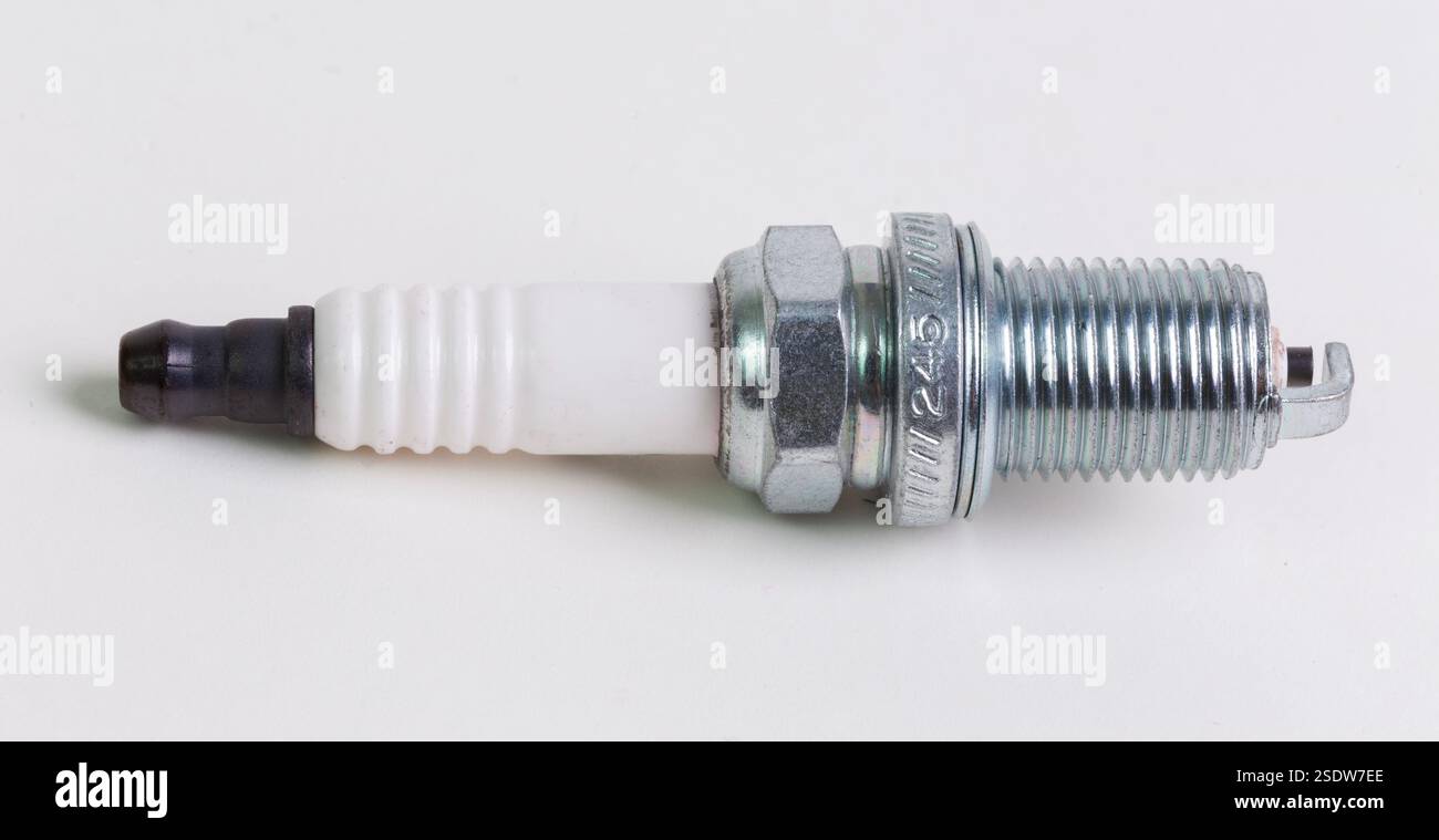 The sparking plug on a white background Stock Photo - Alamy