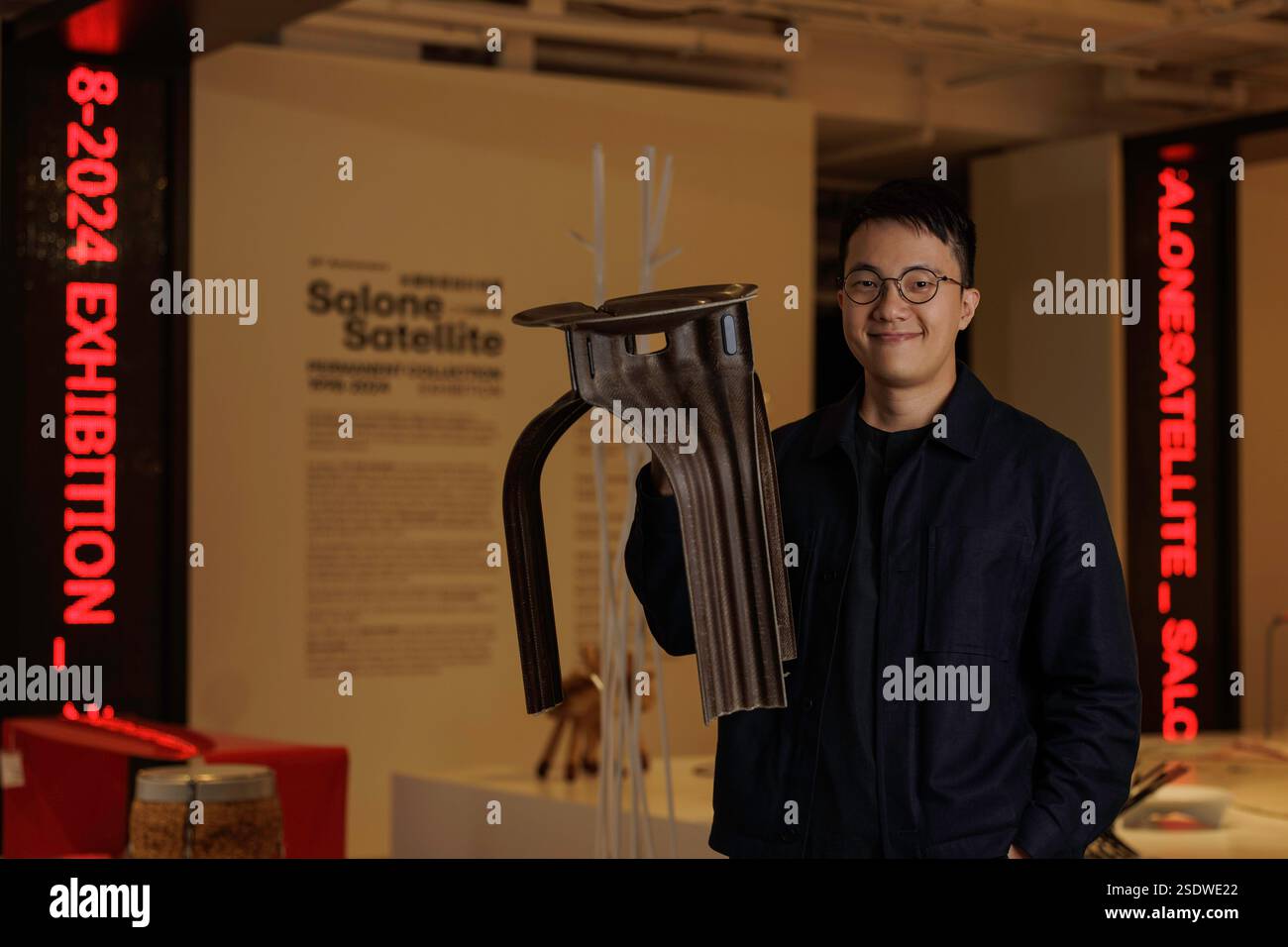 Dennis Cheung holds his Triplex Stool at the opening ceremony of the ...