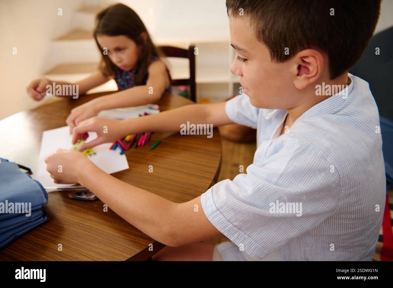 Children enjoy a creative activity session, coloring and crafting at a ...
