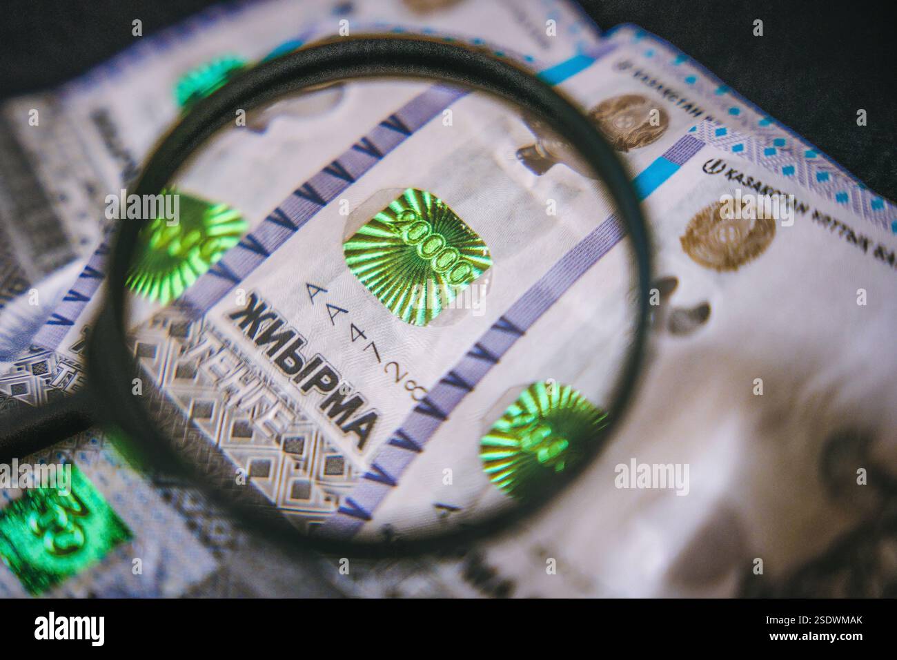 Blurred 20,000 tenge and security element through a magnifying glass ...