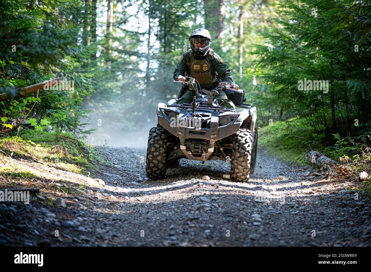 U.S. Border Patrol agent patrolling on an all-terrain vehicle (ATV ...