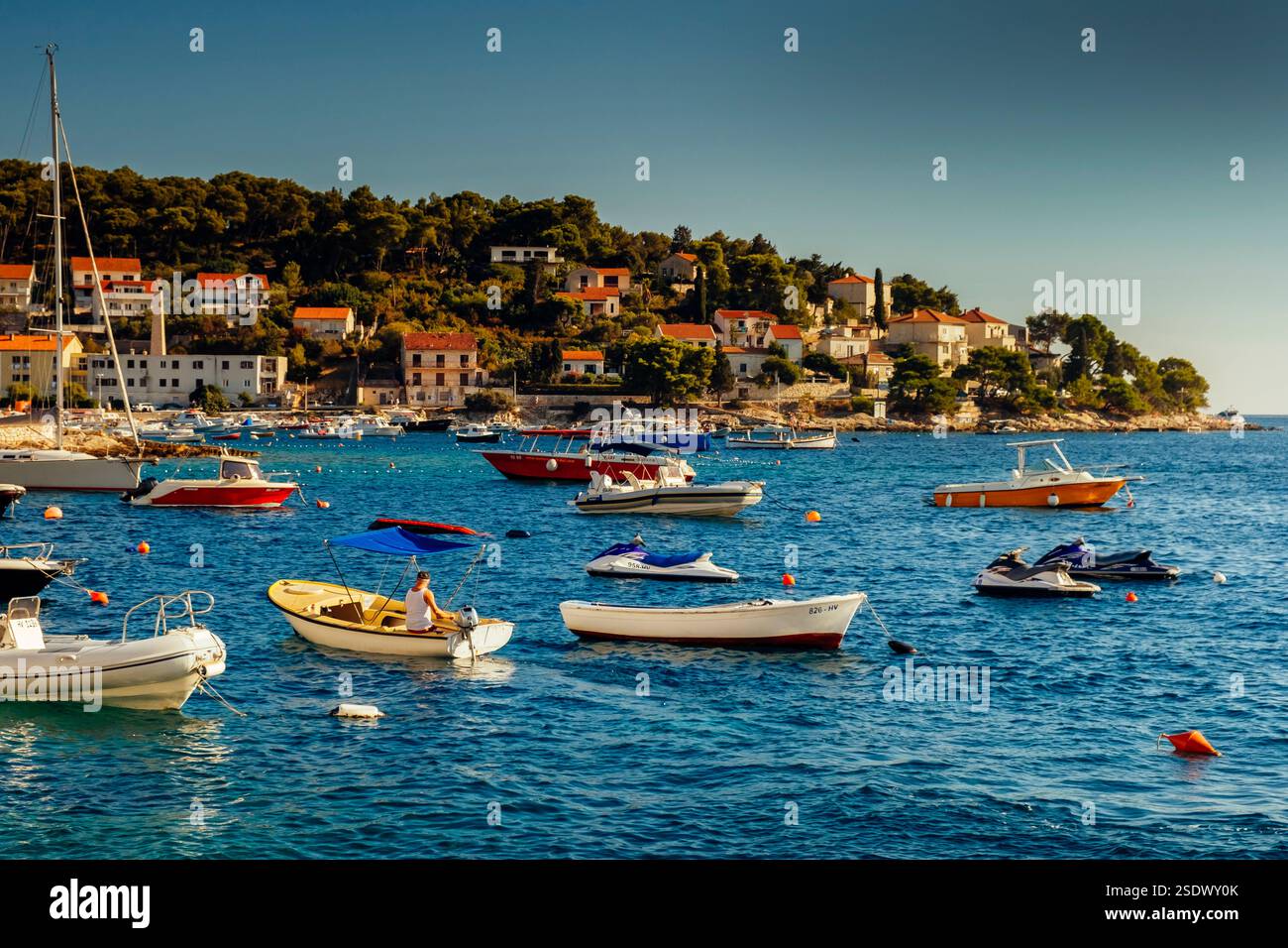 Man driving small boat/ dingy at Krishna Luka beach, Hvar, Island of ...